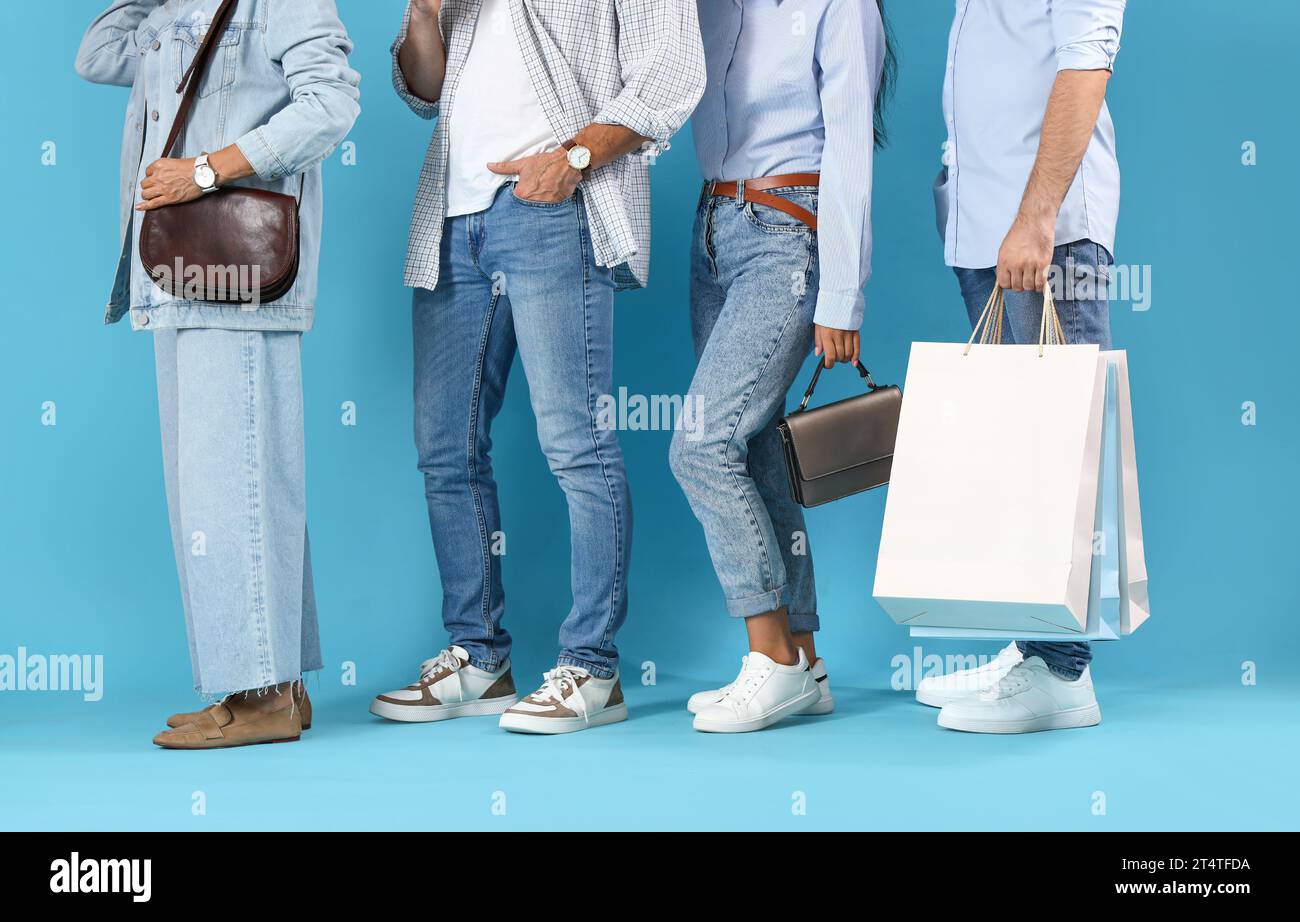 People waiting in line on blue background Stock Photo - Alamy