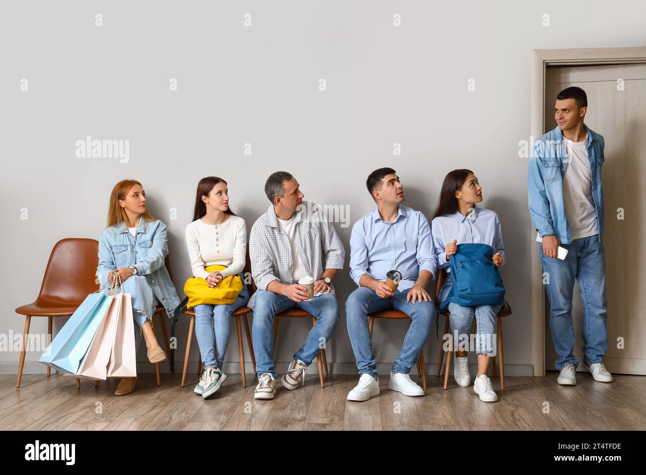 People waiting for their turn in room Stock Photo - Alamy