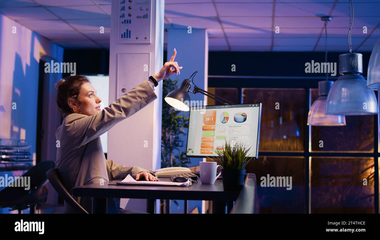 Company employee analyzing metaverse hologram, using holographic image ...
