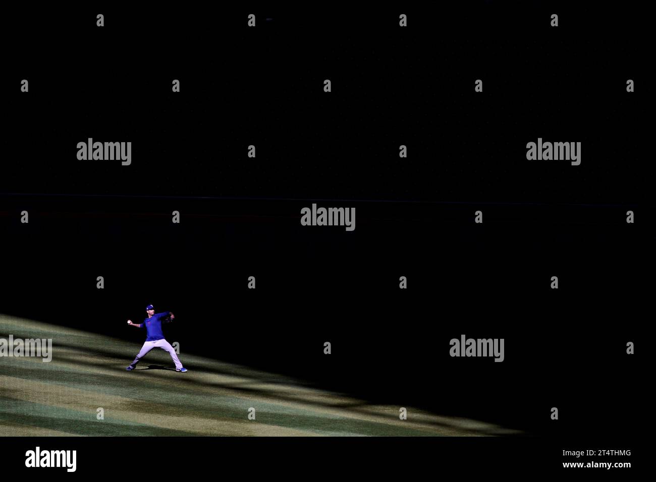 Texas Rangers' Matt Bush throws in the outfield as the roof is openend ...