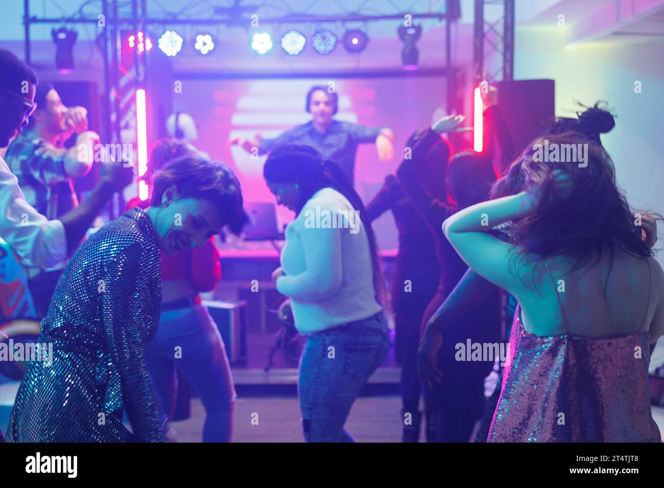 Young people clubbing and partying while dancing in nightclub at ...