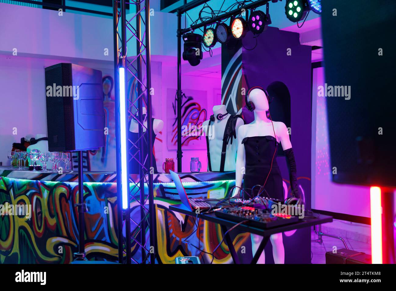 Dj controller and mannequin in headphones on stage in nightclub with ...