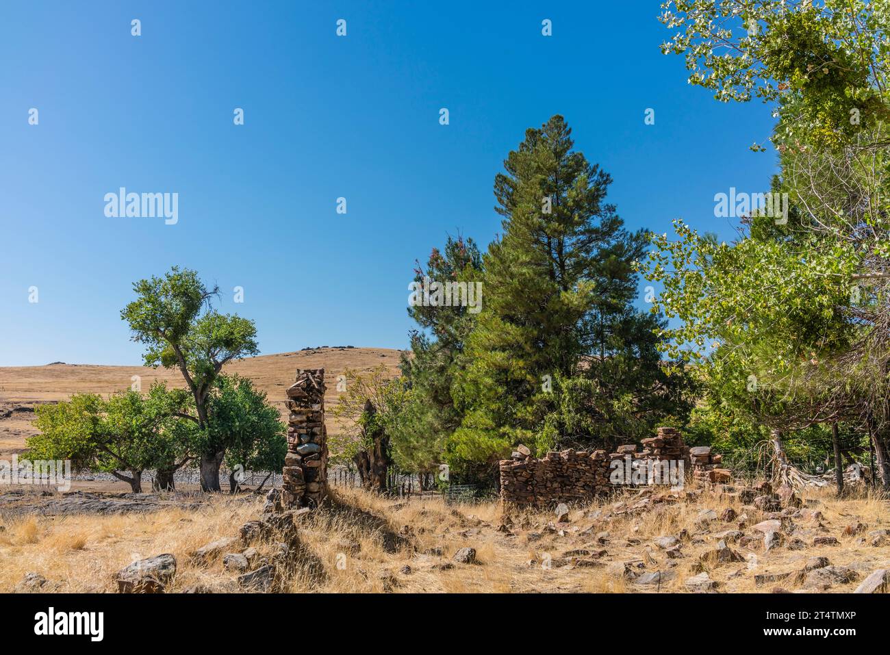 The ruins of a stone building lying in a field in Hornitos, California ...