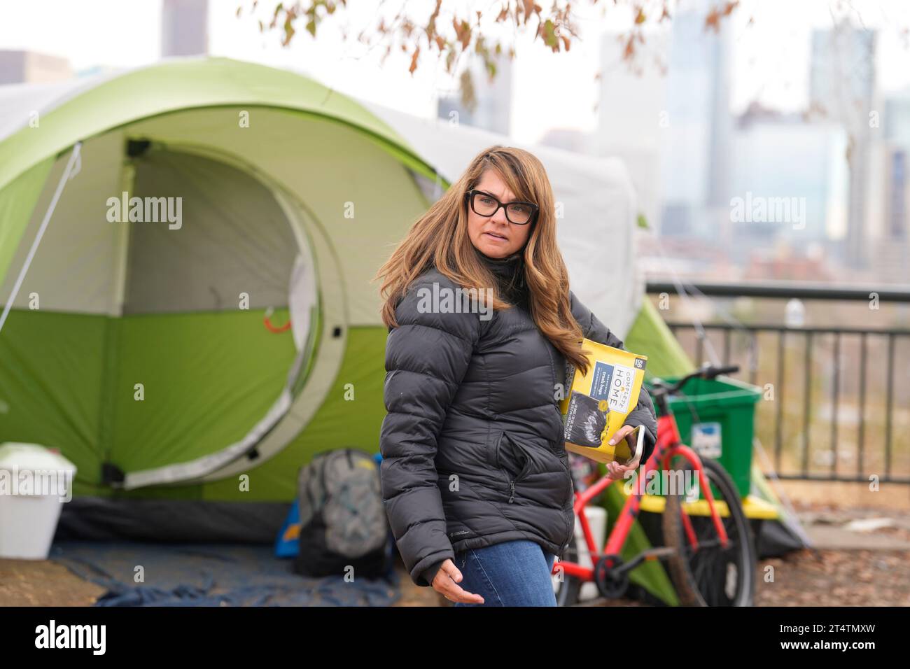 Denver City Councilperson Amanda Sandoval carries a box of garbage bags ...