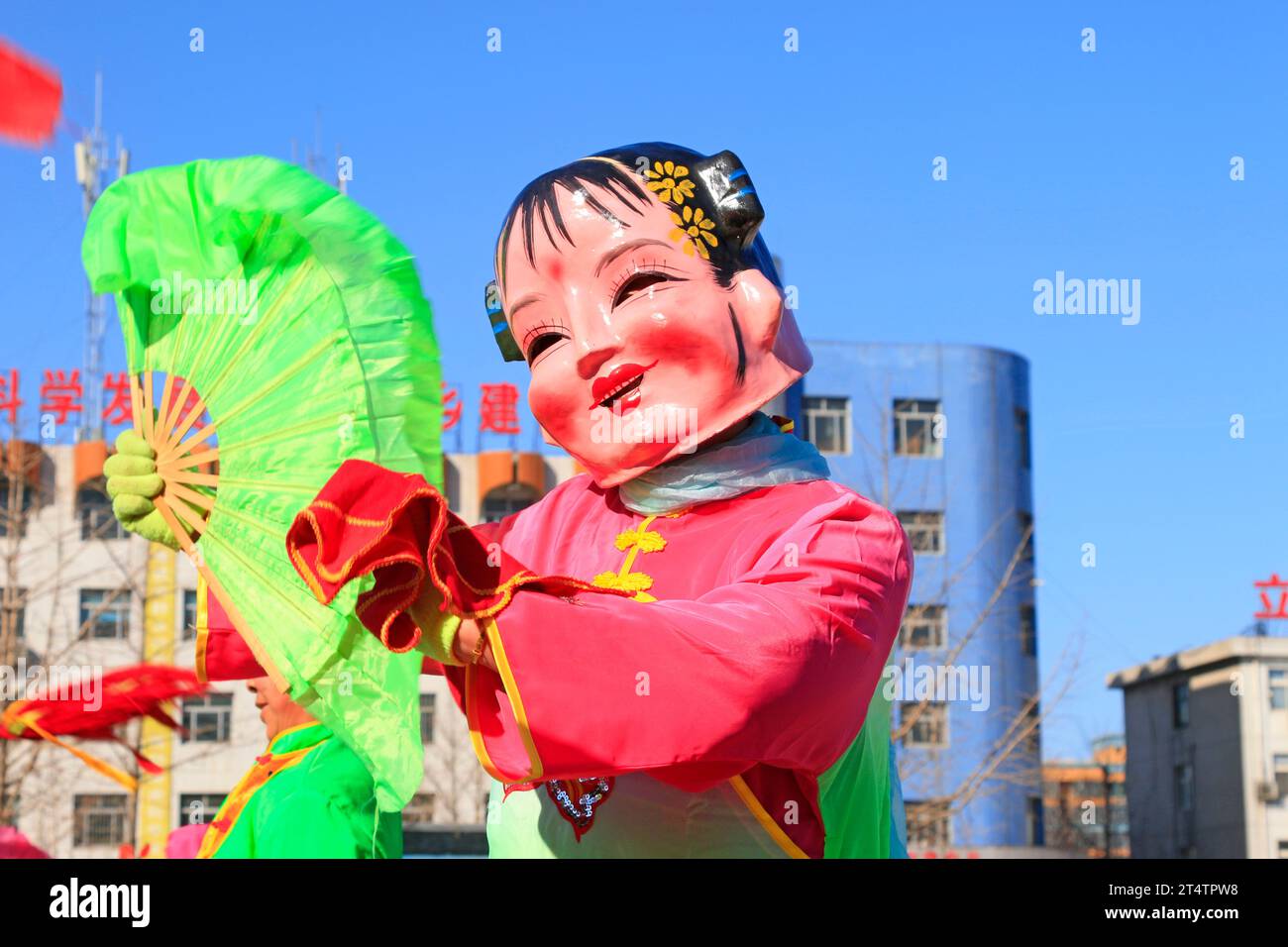 Chinese traditional style yangko folk dance girl mask in the street ...