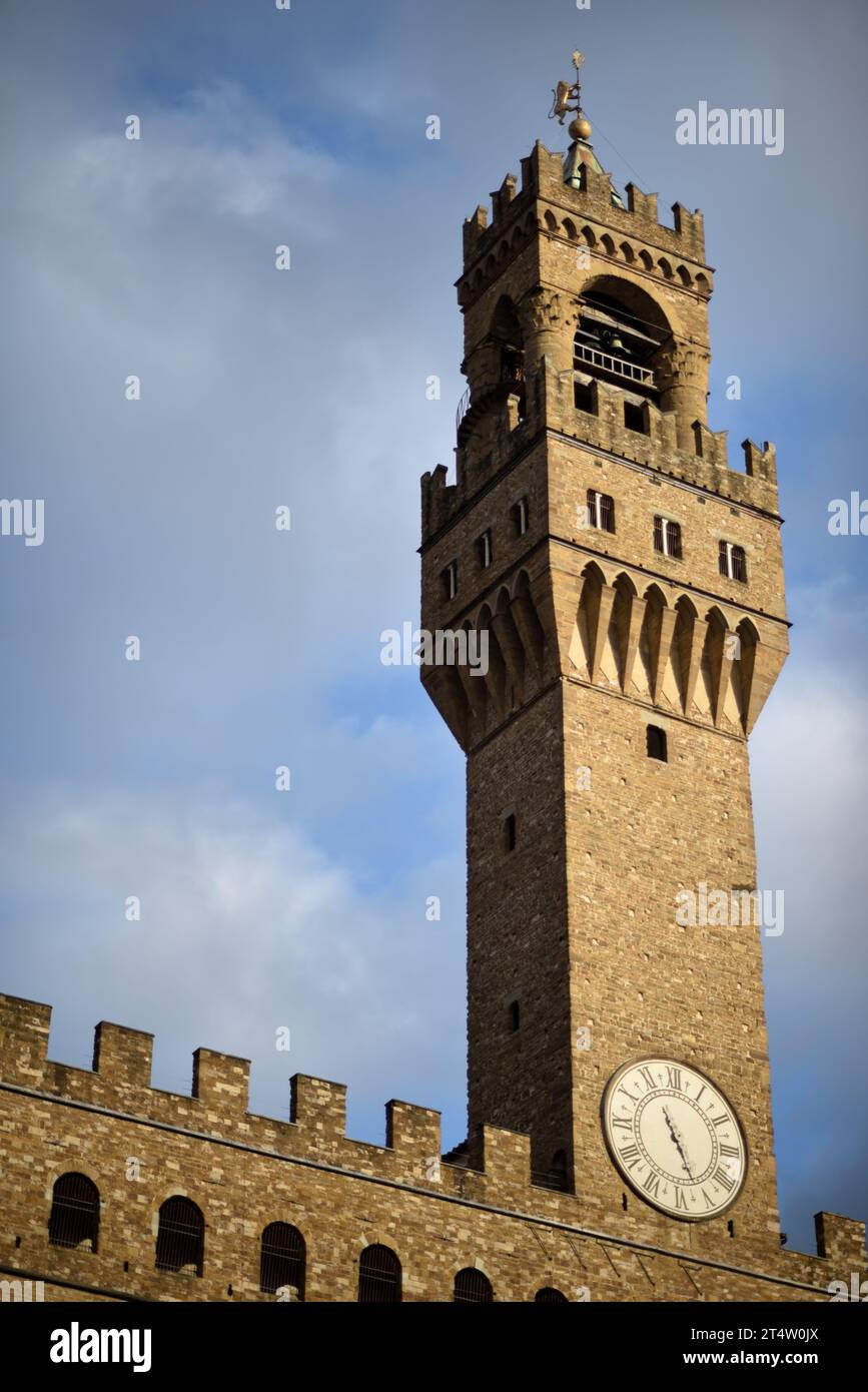 An iconic clock tower adorns the high-rise building, creating a ...