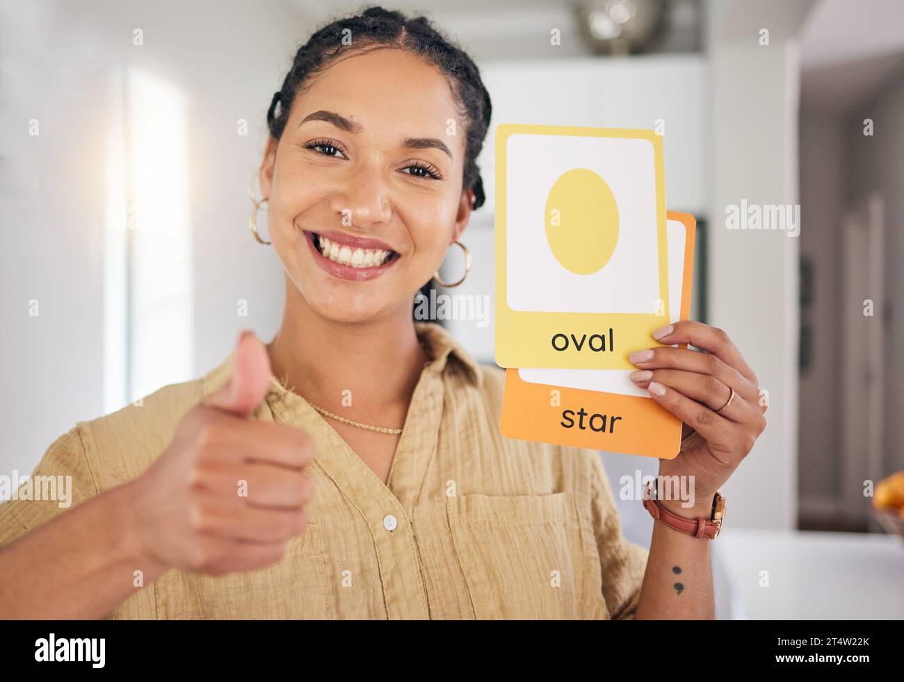 Happy woman, portrait and thumbs up with shape cards for education ...