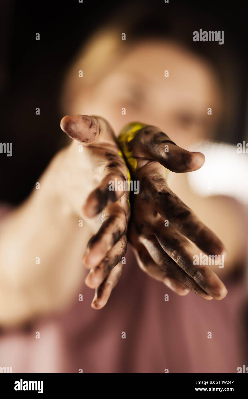 Female artist making an artistic painting with her hands. Girl mixing ...