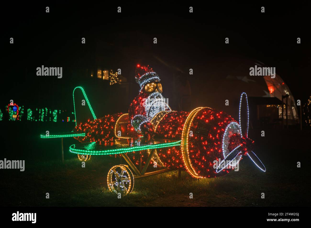 Christmas installation of shining garlands. Santa Claus on a helicopter ...