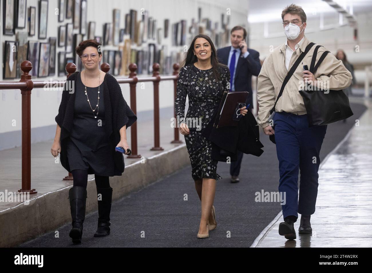 Rep. Alexandria Ocasio-Cortez (D-N.Y.), flanked by aides, walks to a ...