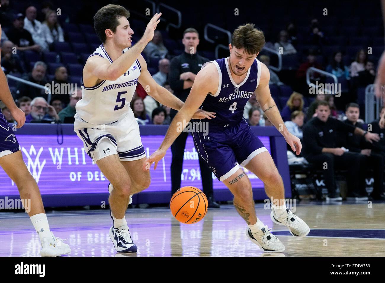 McKendree guard Malcolm Davis, right, drives as Northwestern guard Ryan Langborg defends during ...