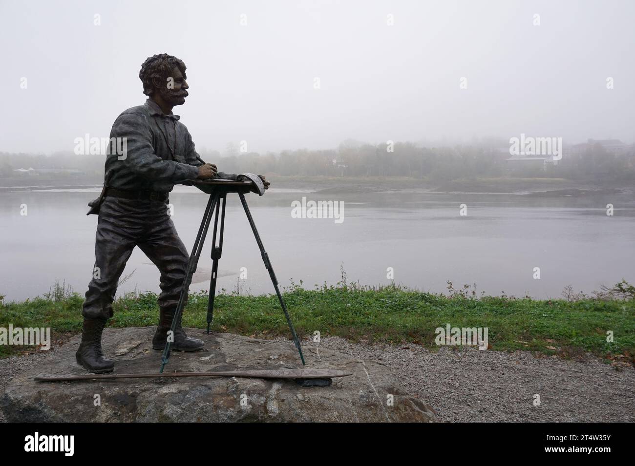 Statue of a surveyor on the bank of the St Croix river, St Stephen, New ...