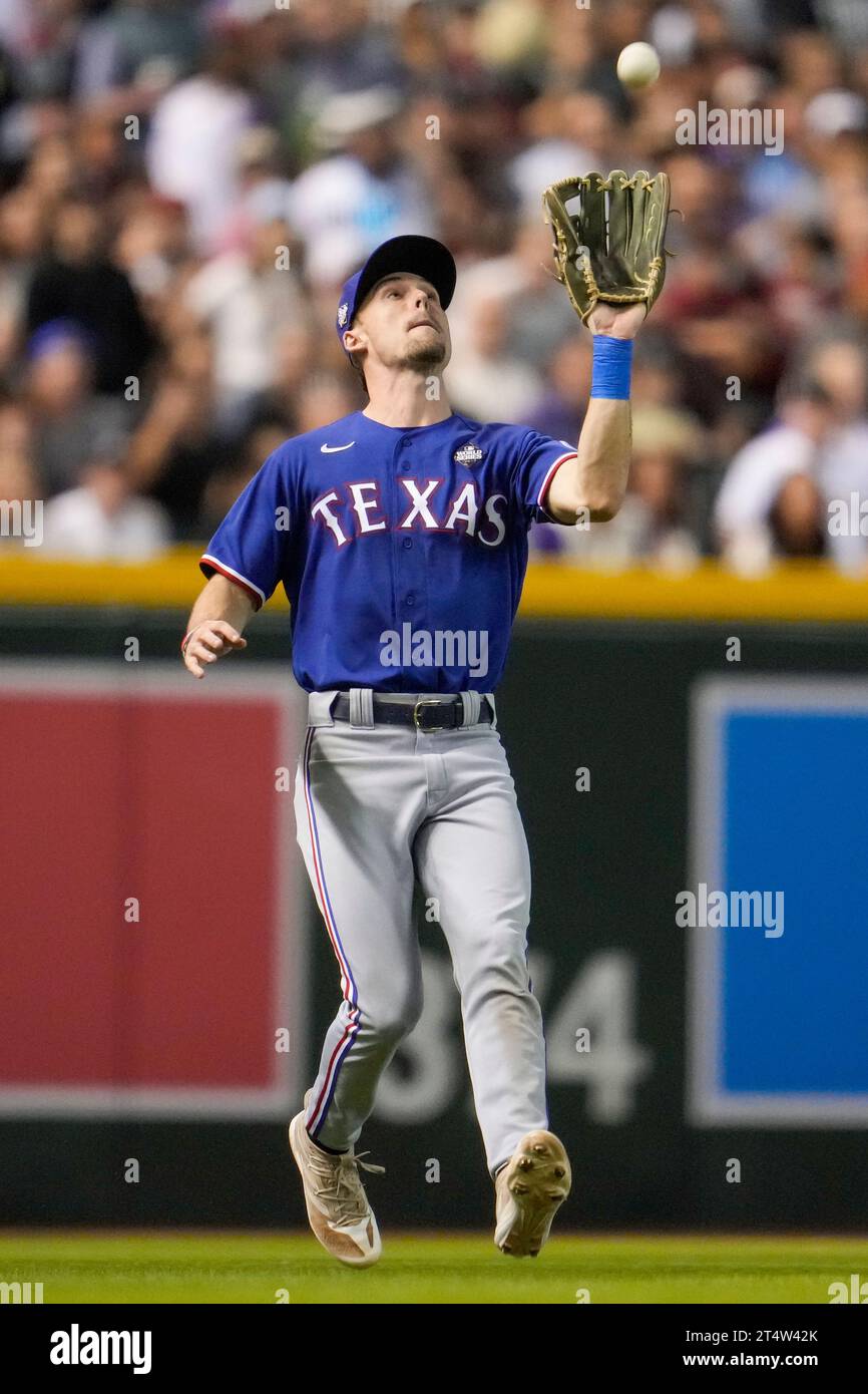 Texas Rangers left fielder Evan Carter catches a fly ball by Arizona ...