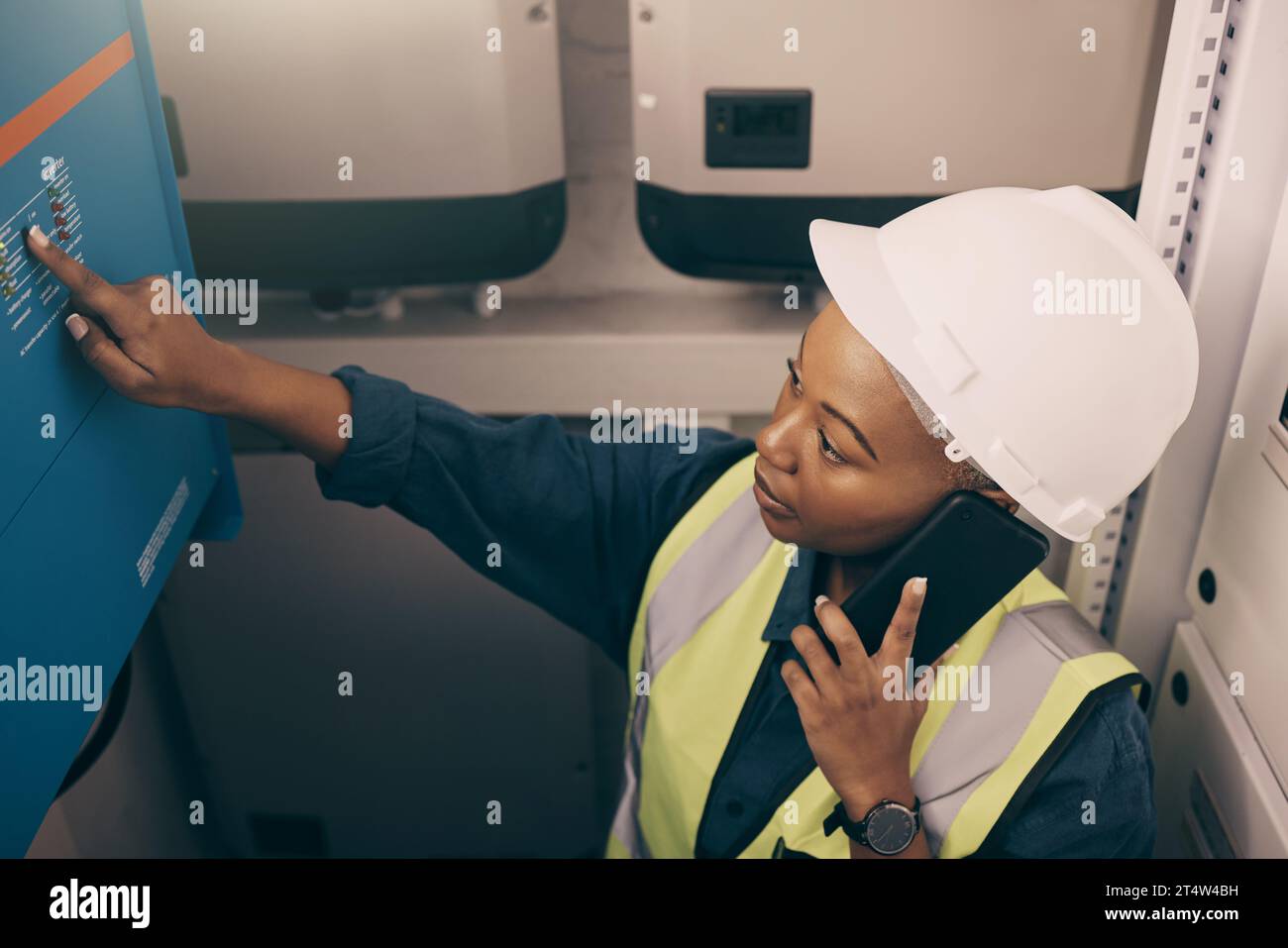 Black woman, engineering technician and phone call in control room to ...