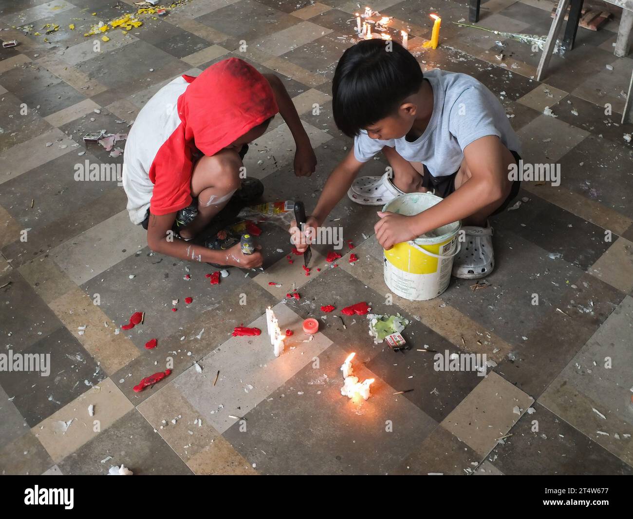 Caloocan, Philippines. 01st Nov, 2023. Two kids play with melted candle ...