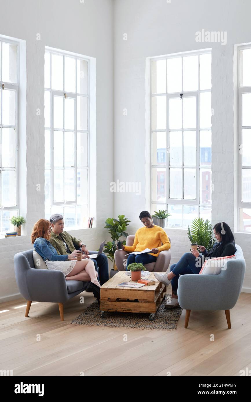 Startup, meeting and creative employees in the office lounge or ...