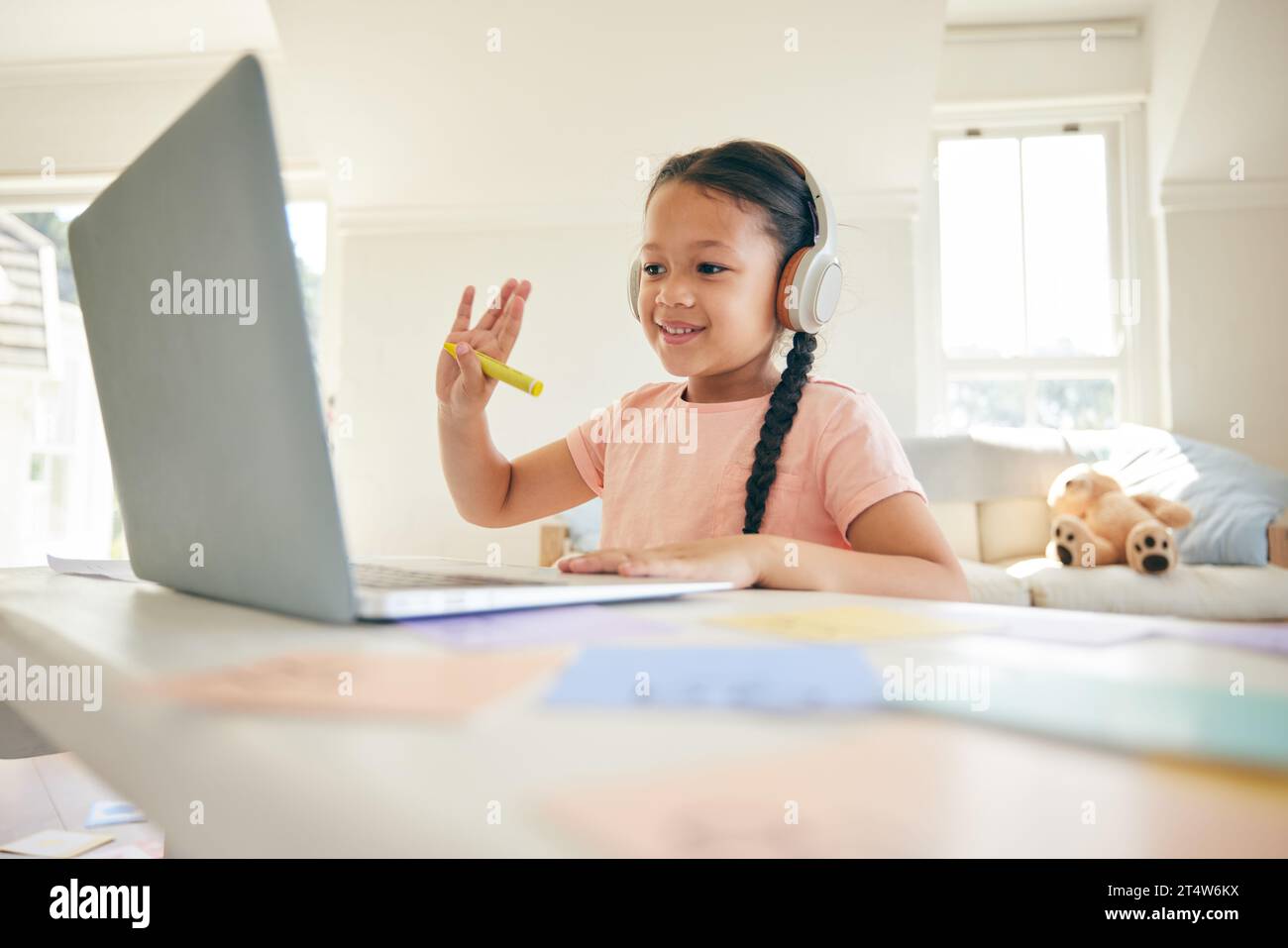 Laptop, elearning and child on a video call wave in a class doing ...
