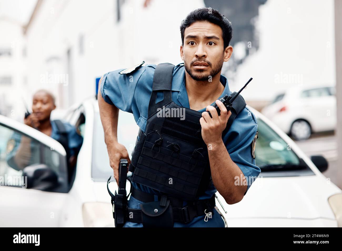 Asian man, police and walkie talkie with gun in city for suspect ...