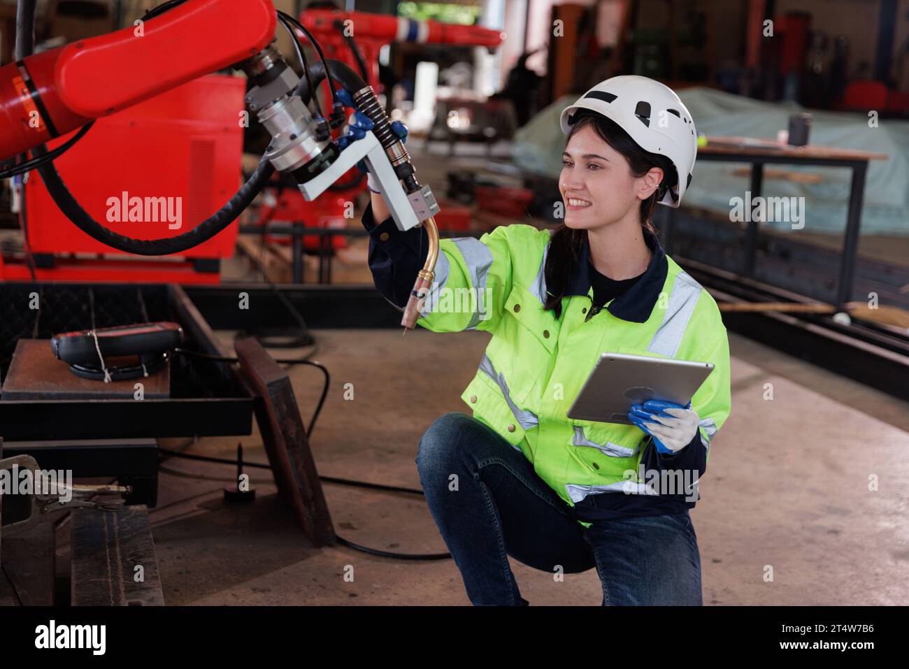Female automation engineer wear vest with helmet safety checking and ...