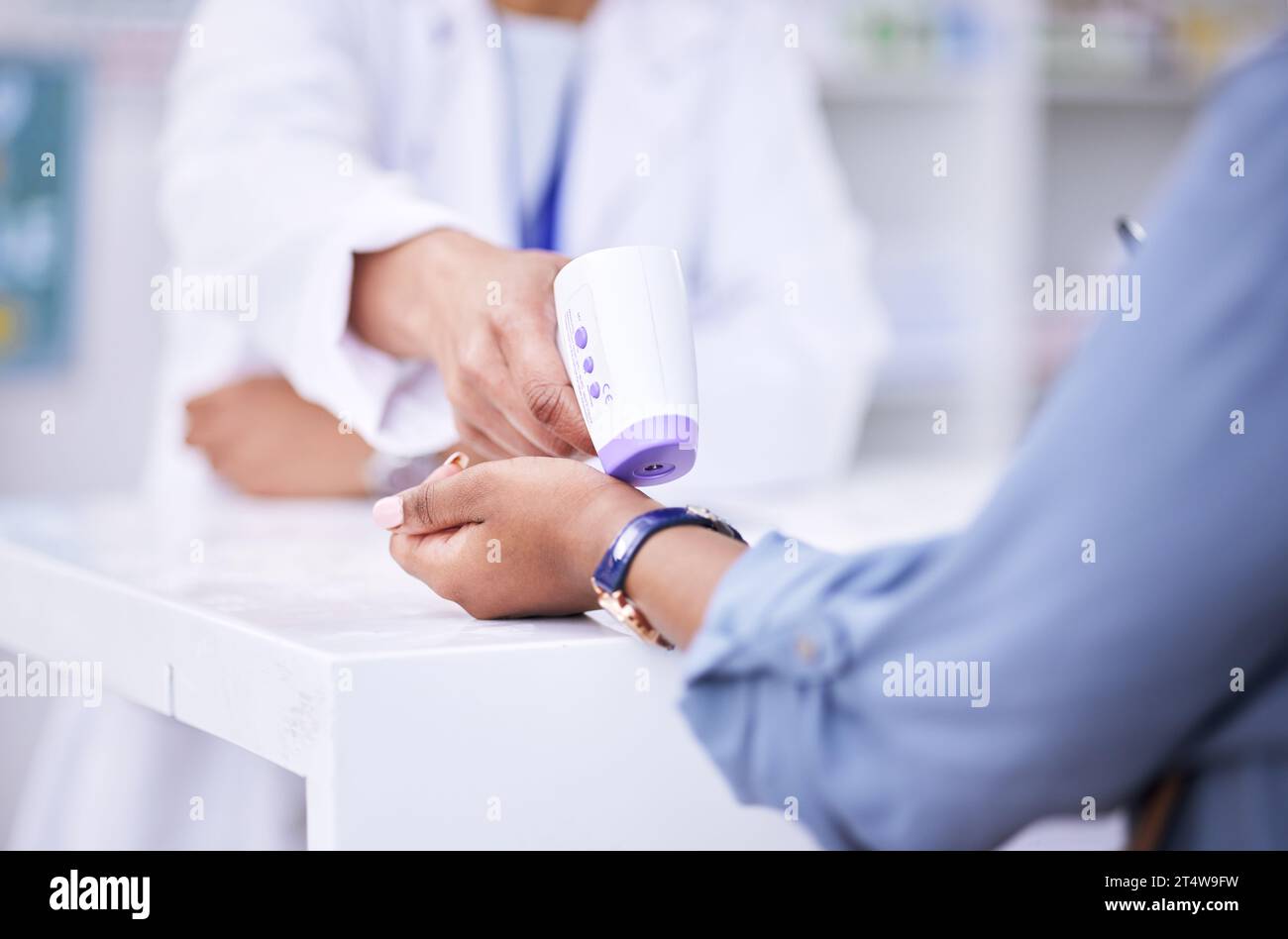 Thermometer, temperature check and hands of people at a pharmacy for ...