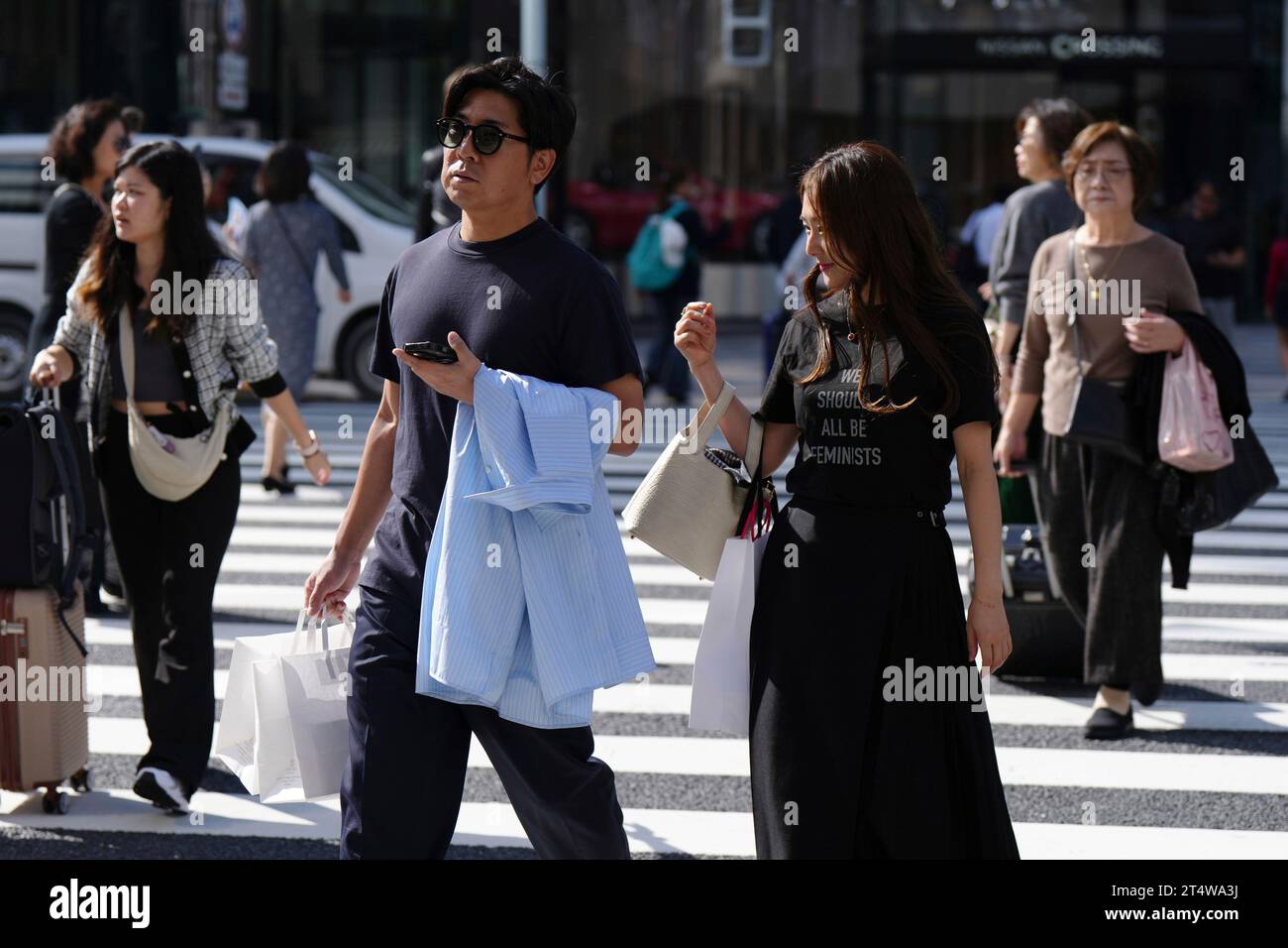 People visit Ginza area in the strong sunshine in Tokyo on Nov. 2, 2023 ...