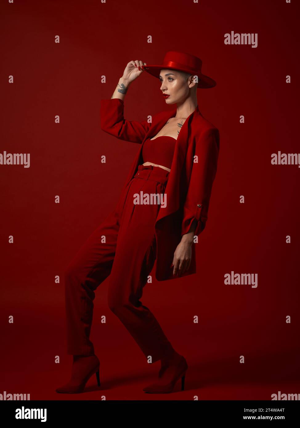 Aesthetic, fashion and a woman walking on a red studio background for ...