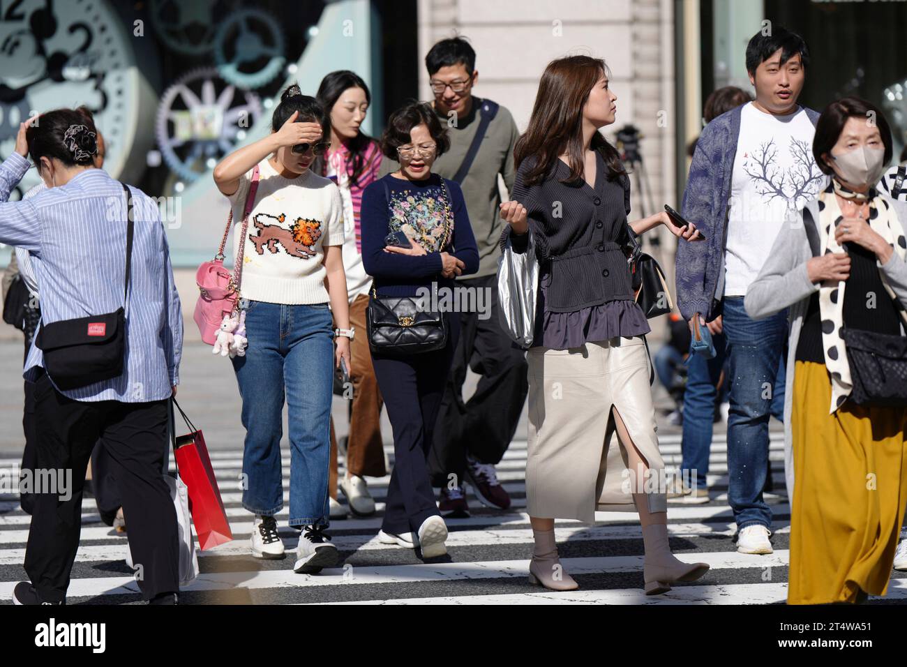 People visit Ginza area in the strong sunshine in Tokyo on Nov. 2, 2023 ...