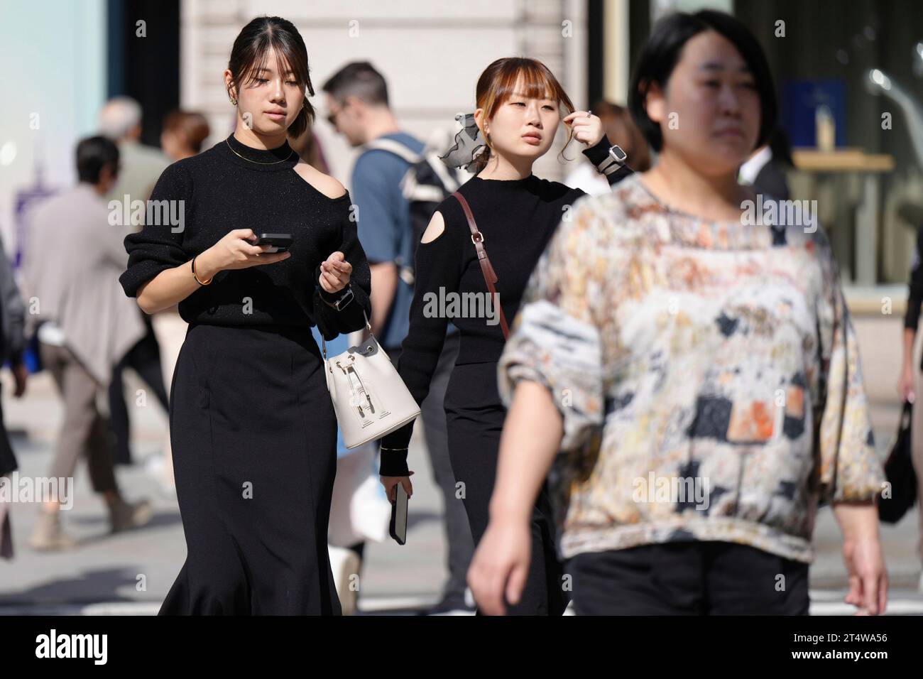 People visit Ginza area in the strong sunshine in Tokyo on Nov. 2, 2023 ...