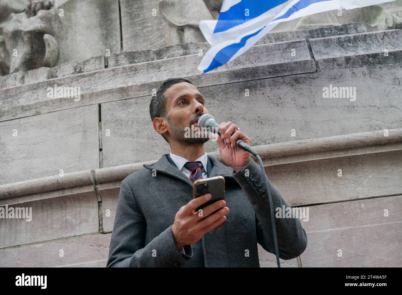 Acting Consul General of Israel in New York Tsach Saar speaks as people ...