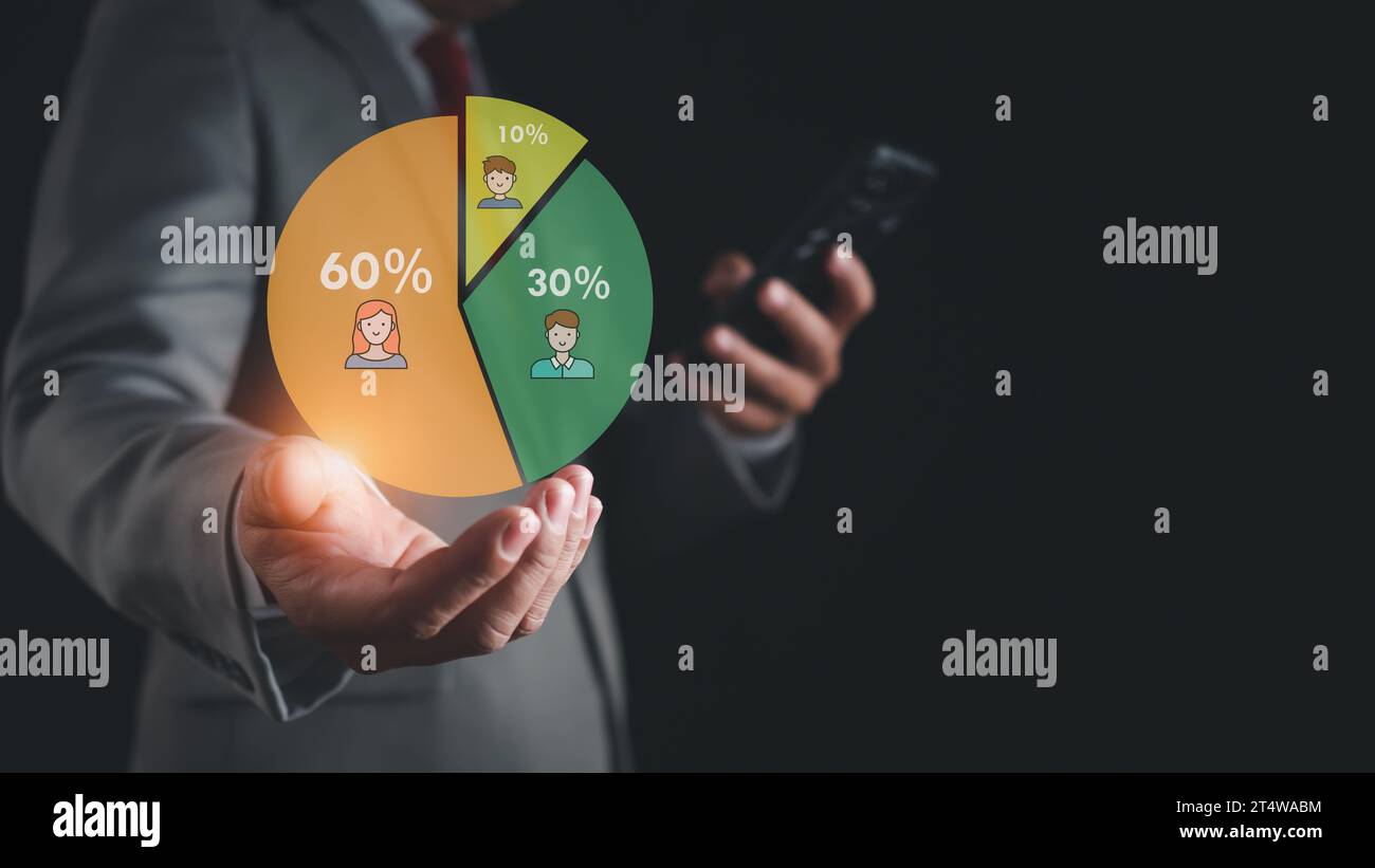 Businessman holds a chart to represent business target group management ...