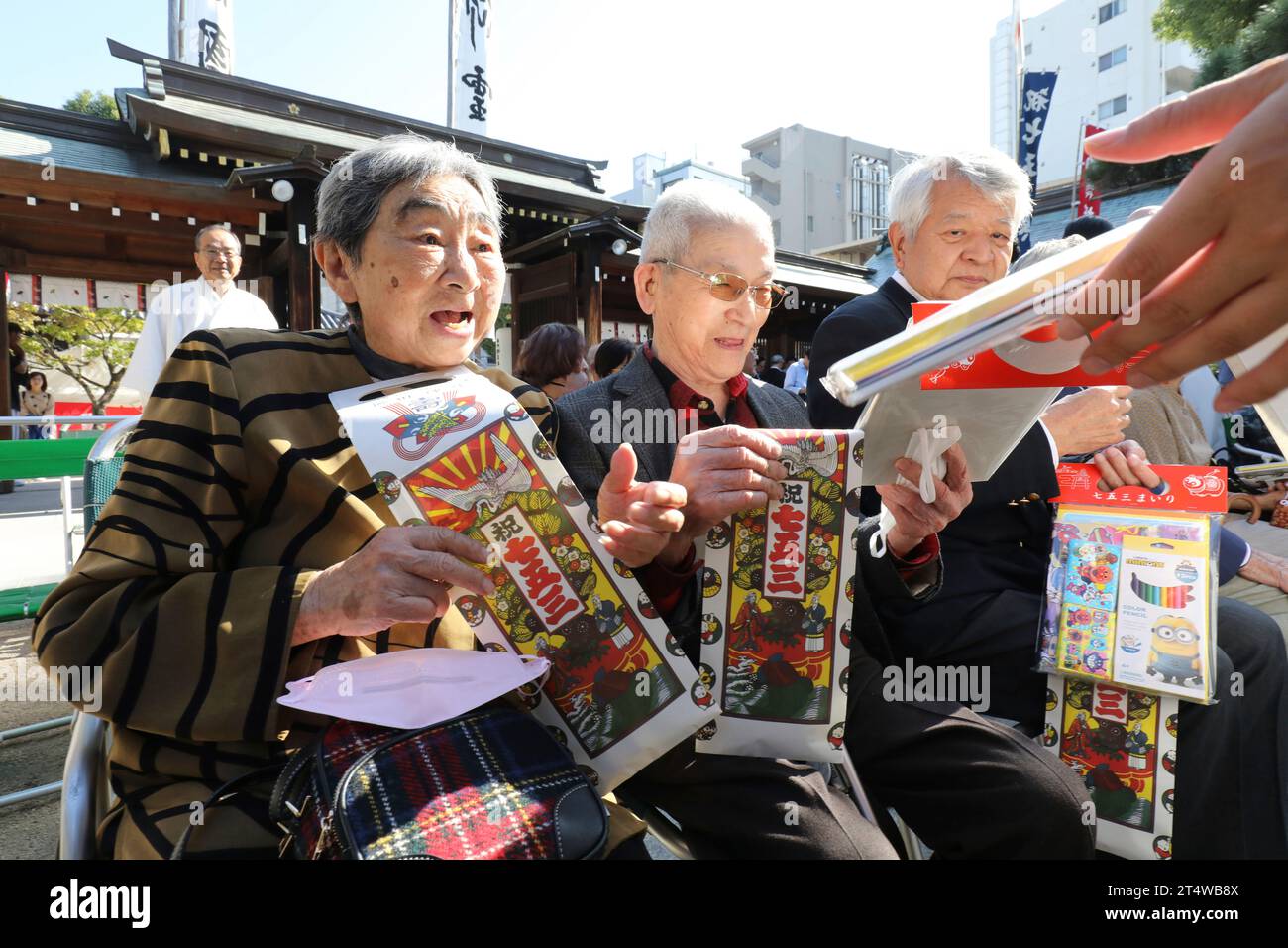 Elder worshippers smile after receiving souvenirs such as Chitose candy ...