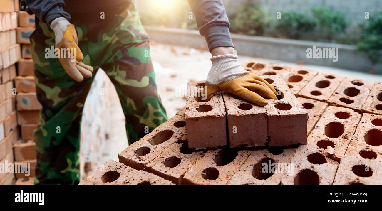 Construction worker carrying bricks hi-res stock photography and images ...