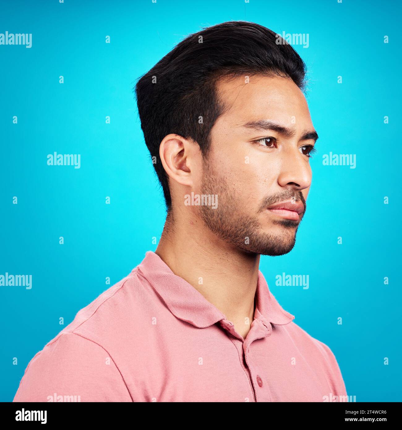 Thinking, serious and profile of Asian man in studio isolated on a blue ...