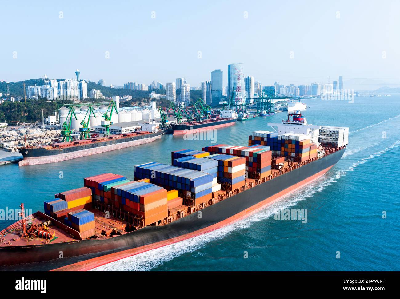 Large cargo container ship arriving in port Stock Photo - Alamy