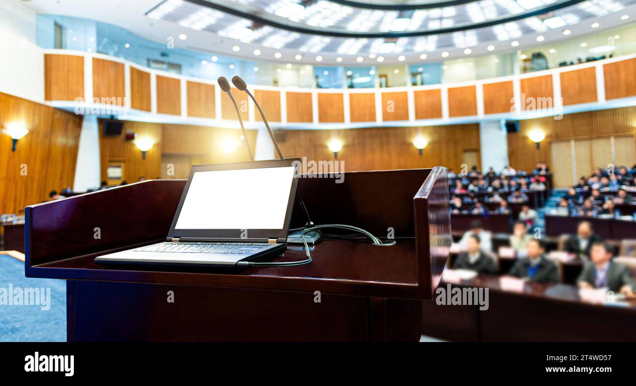 Speaker's table with laptop in conference room Stock Photo - Alamy