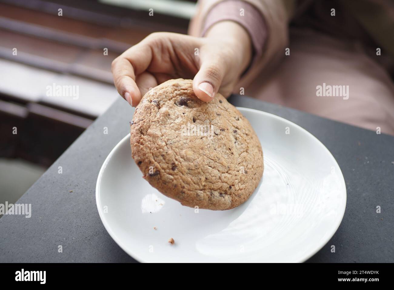 Women hand pick chocolate cookies hi-res stock photography and images ...
