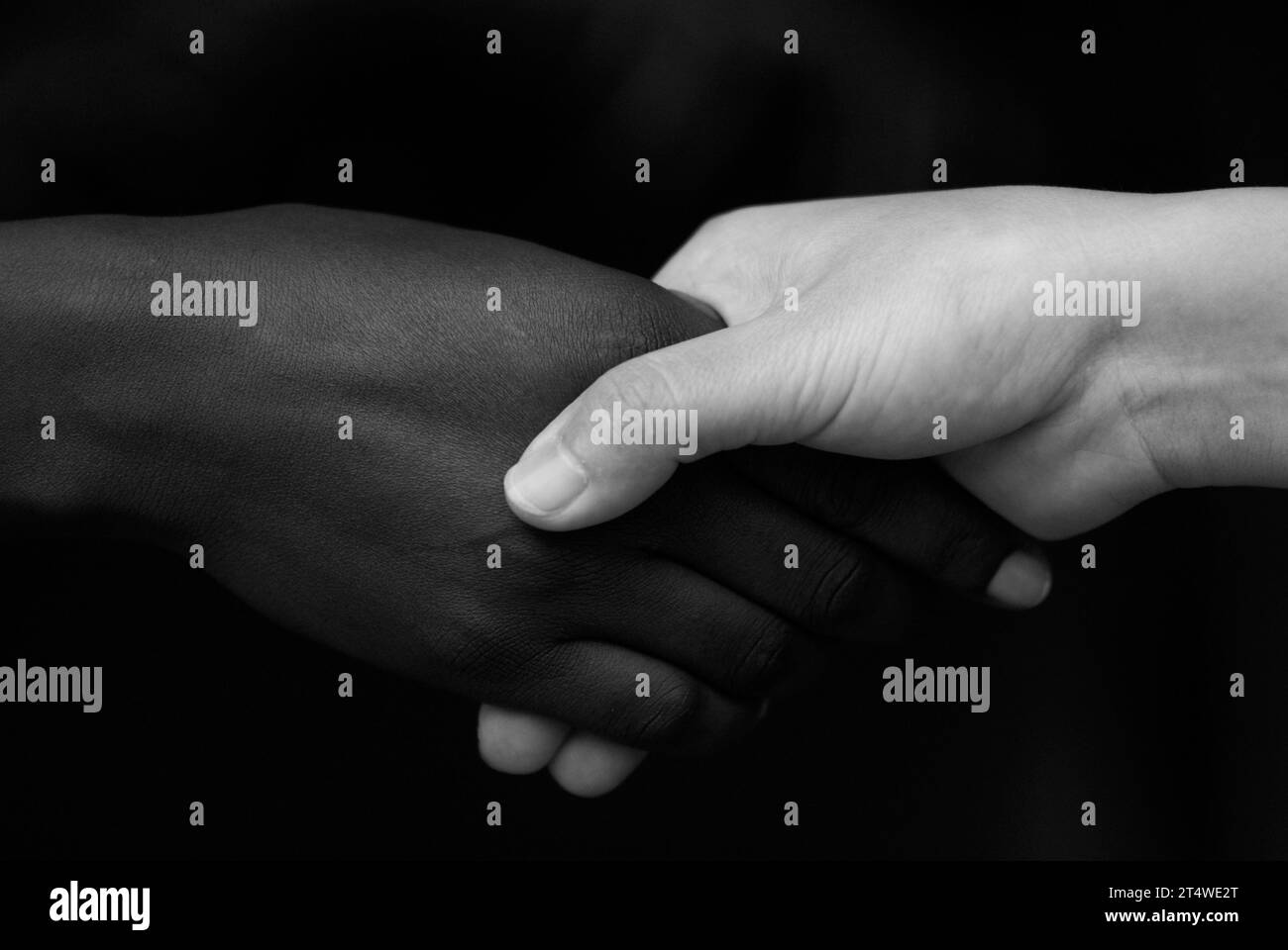 Black and east asian race of people shaking hands Stock Photo - Alamy
