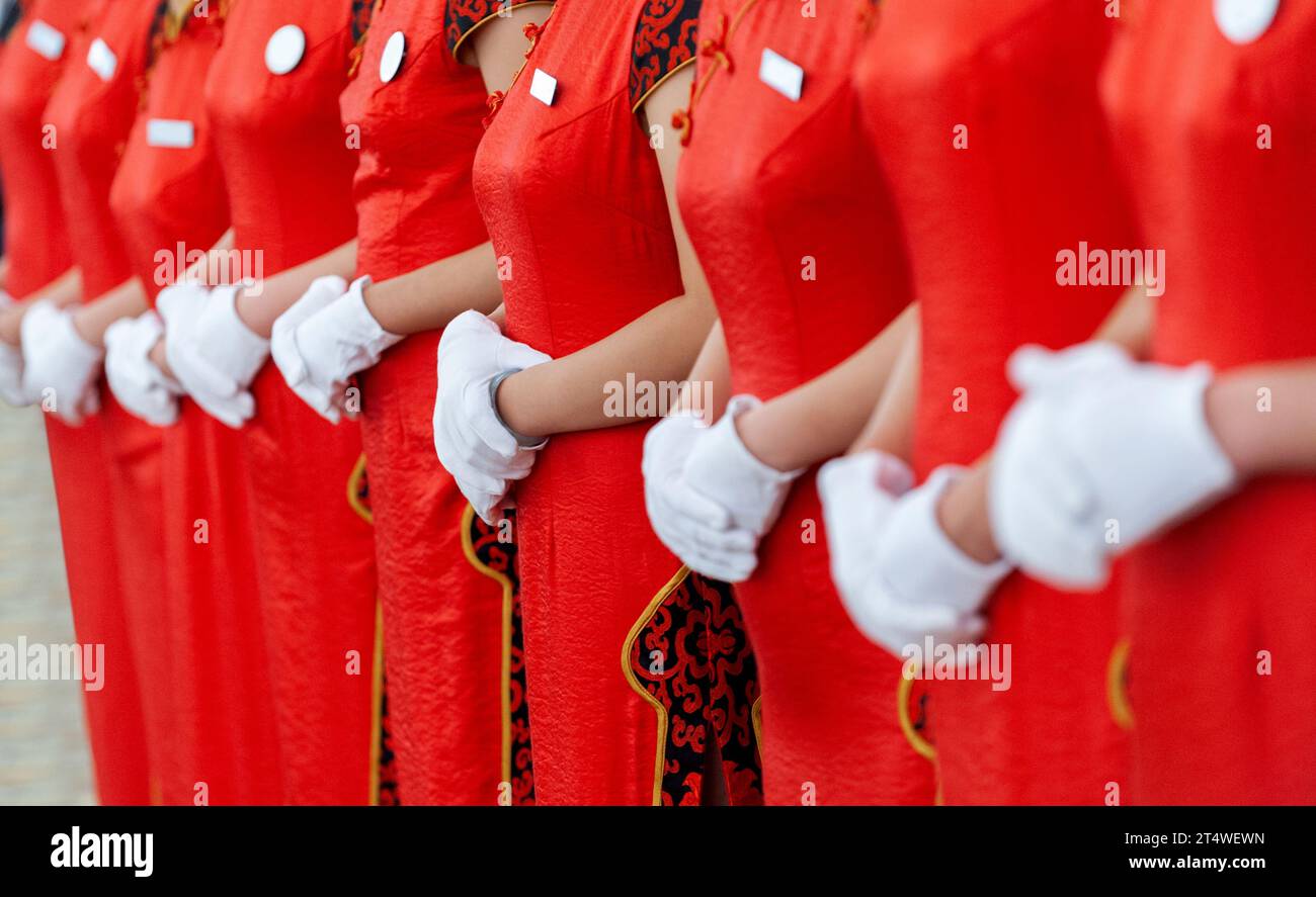 Chinese waitress dressed neatly in red cheongsam and white gloves Stock ...