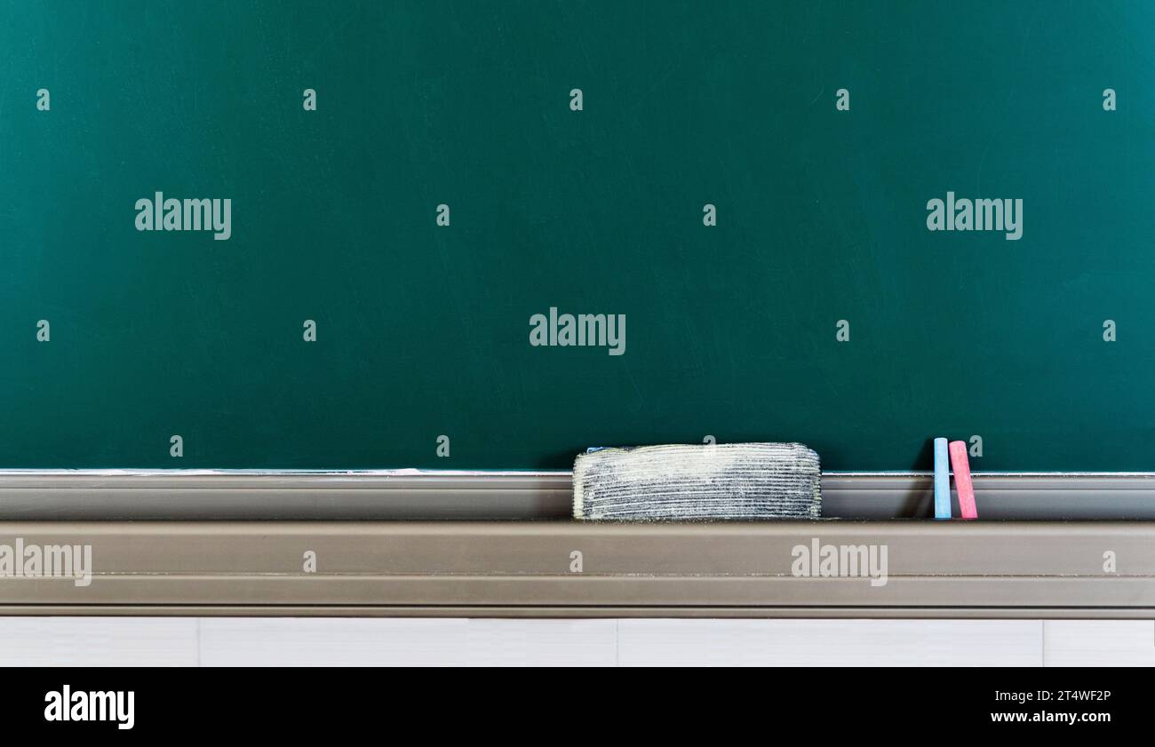 School chalkboard with chalks and eraser Stock Photo - Alamy