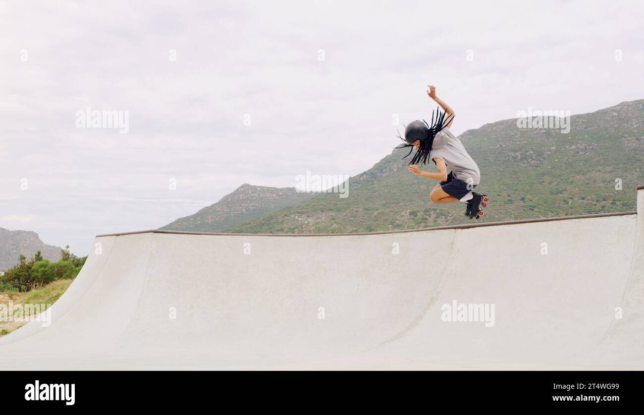 Sports, roller skates and jump with black man in skate park for fitness ...