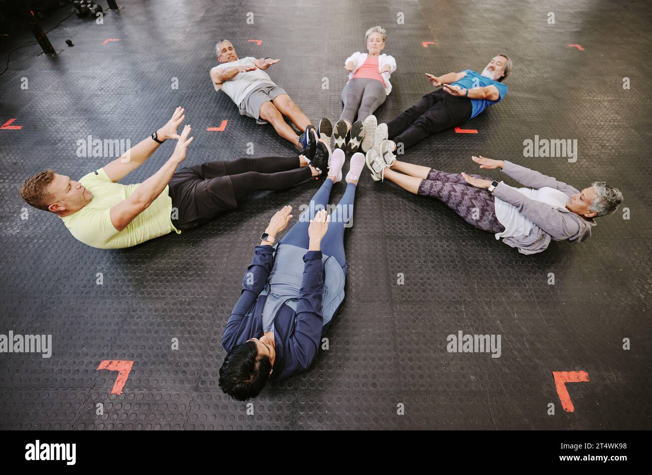 Gym, fitness workout and group doing exercise for abdomen together in a ...