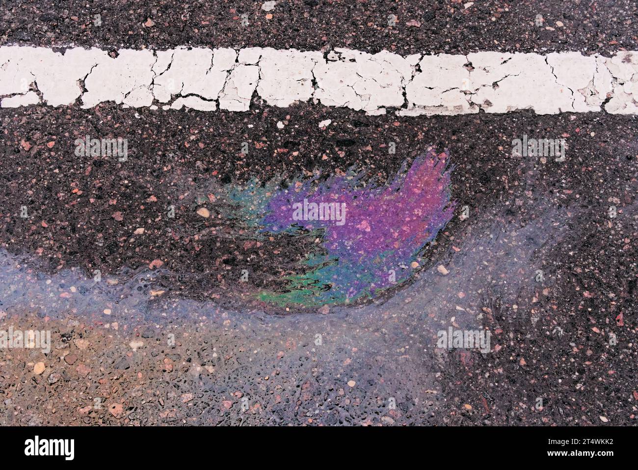 Oil spill on wet asphalt, parking lot with dividing line Stock Photo ...