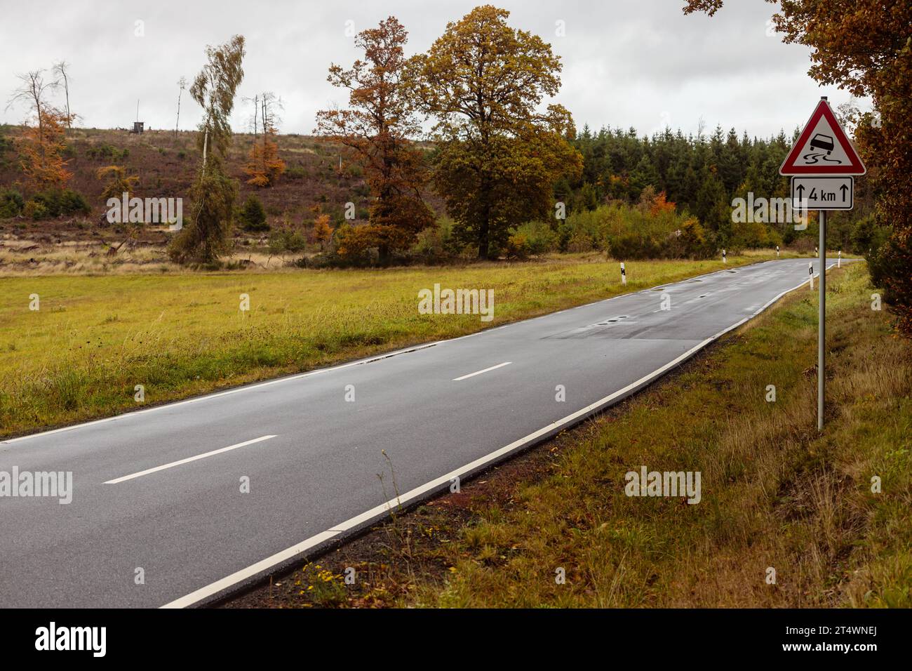 Scenic autumn landscape along a winding road, low mountain range Eifel ...