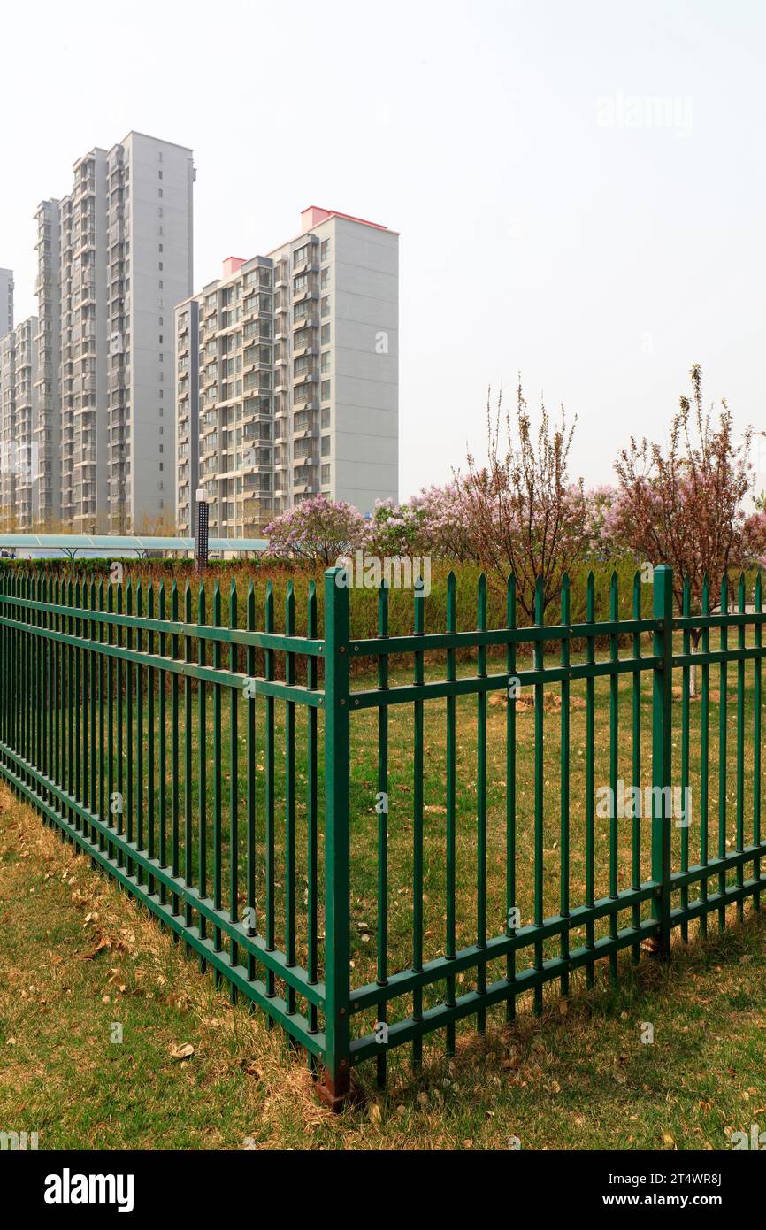 Metal fences and buildings Stock Photo - Alamy