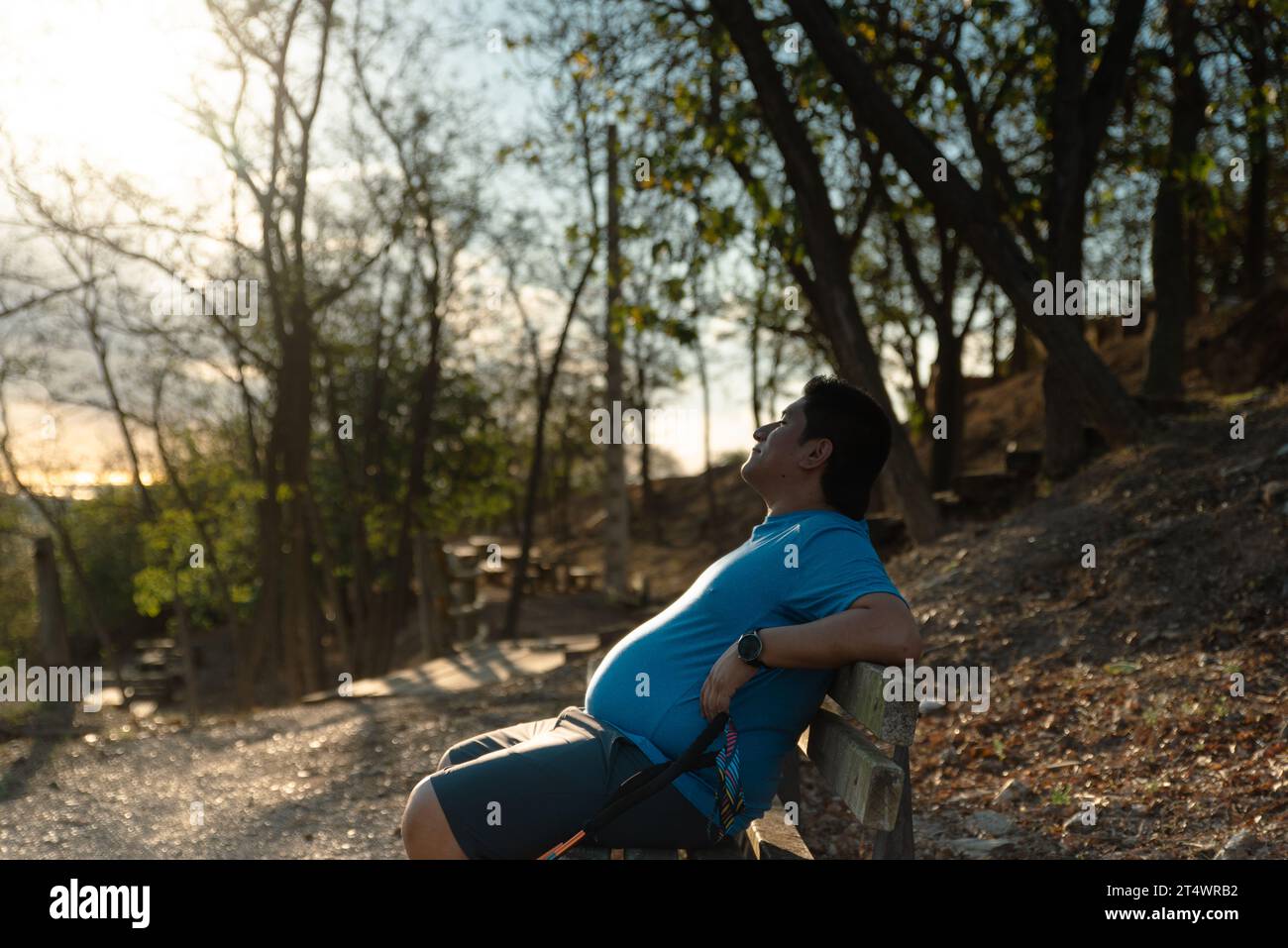Overweight man stops his training to contemplate the landscape in the ...