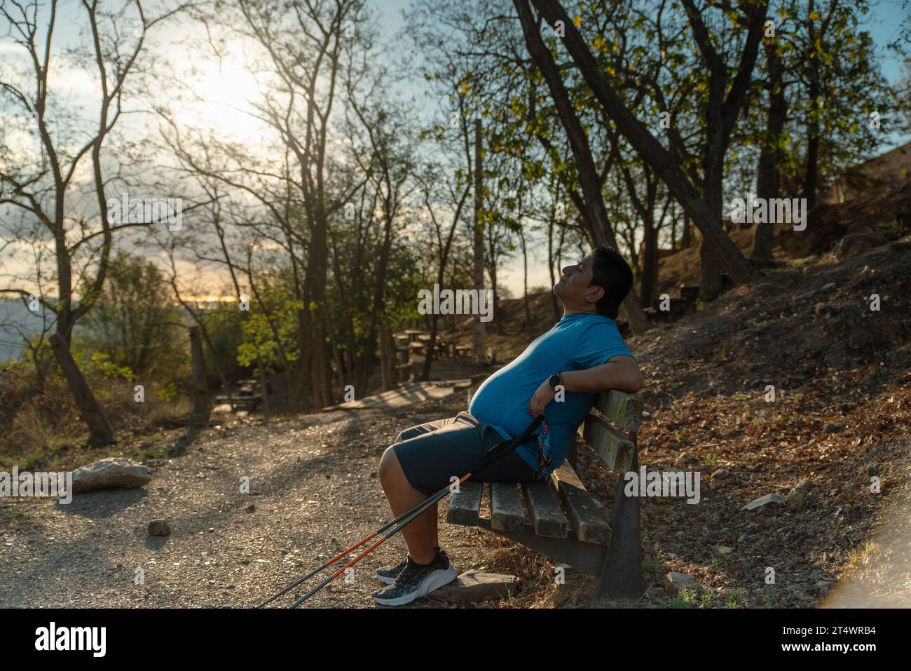 Overweight man stops his training to contemplate the landscape in the ...
