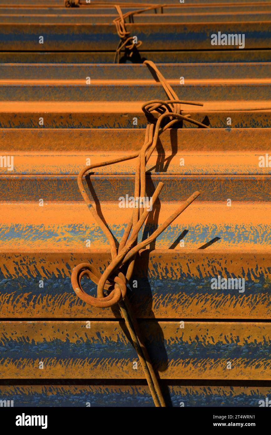 steel plate banding piled up together, closeup of photo Stock Photo - Alamy
