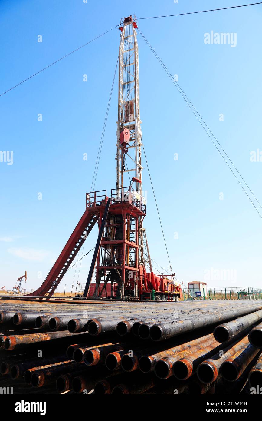 Oil drilling derrick and metal pipe Stock Photo - Alamy