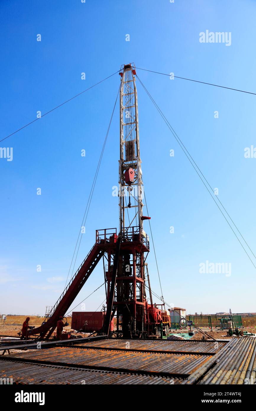 Oil drilling derrick and metal pipe Stock Photo - Alamy