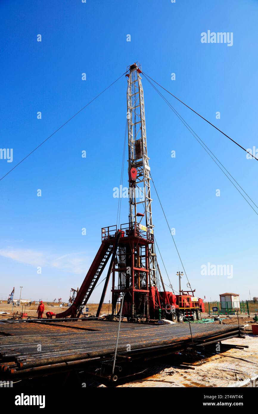 Oil drilling derrick and metal pipe Stock Photo - Alamy